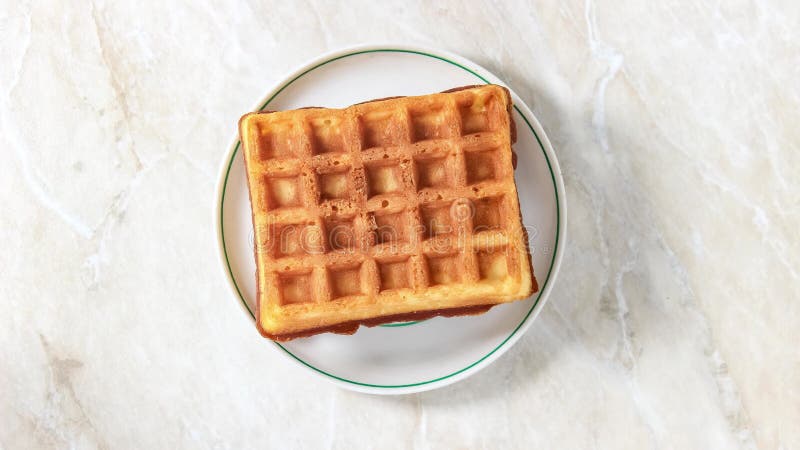 Soft Rectangular Waffles are Spinning on a Saucer. Delicious Dessert ...