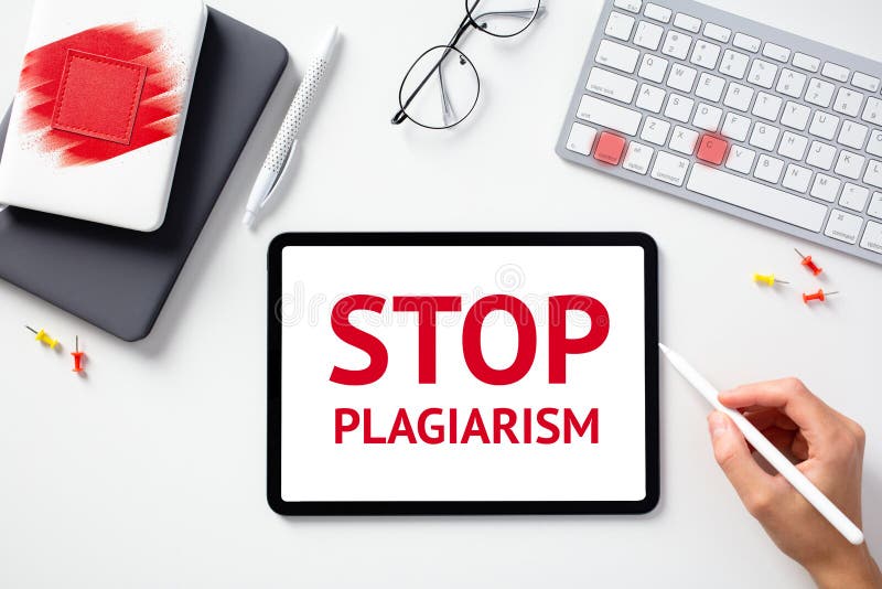 STOP PLAGIARISM Message on Tablet Screen, Keyboard, Glasses, Notebooks ...