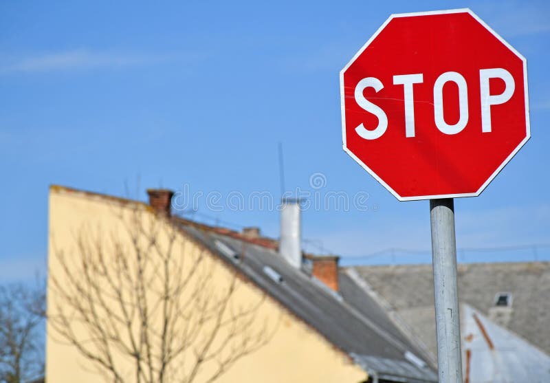 Stop Sign Against Blue Sky in Front of a Building Stock Image - Image ...