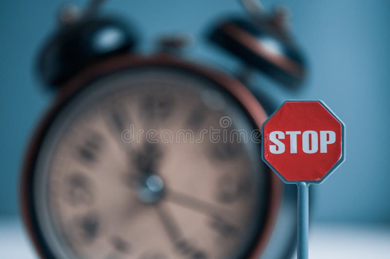 Stop Sign and Alarm Clock on Blue Background. Stop Time Concept Stock ...