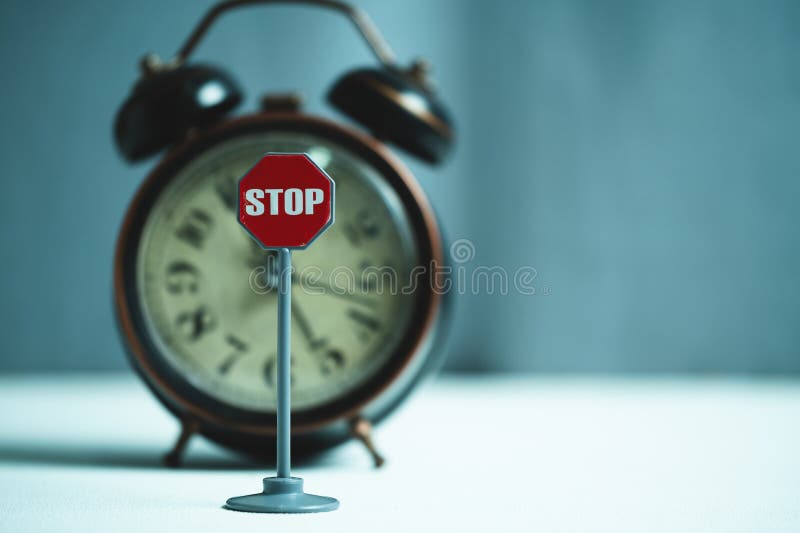 Stop Sign and Alarm Clock on the Table. Time Management Concept Stock ...