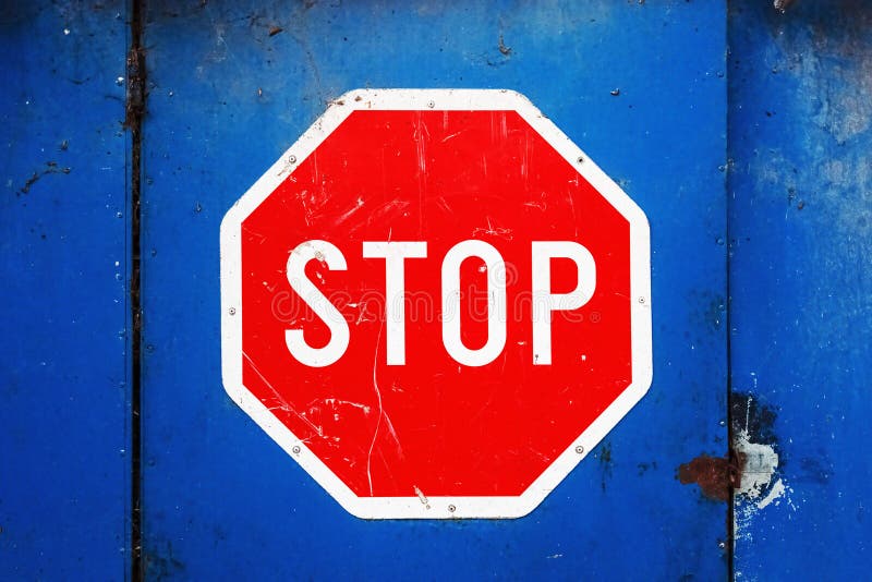 Stop Sign on Blue Garage Door Stock Photo - Image of metallic, worn ...