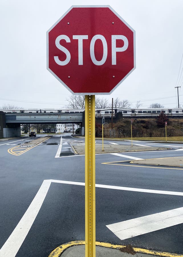 Stop Sign by Dangerous Intersection with Train Tressel in Background ...