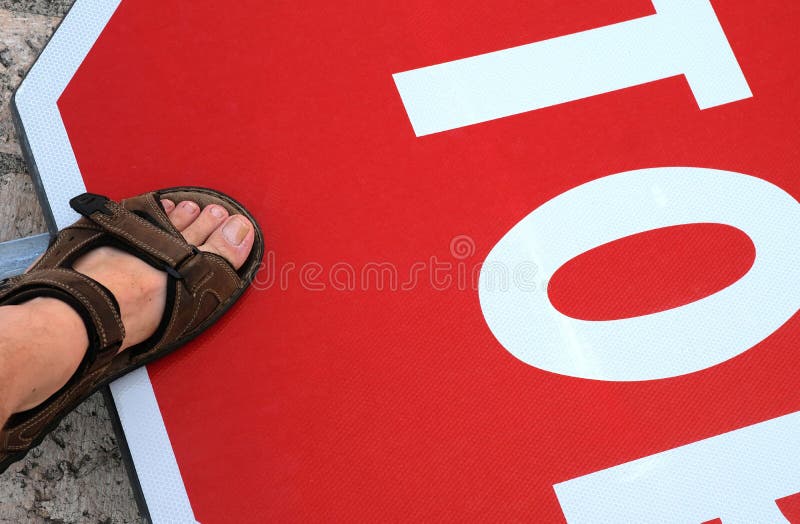 Stop Sign on the Floor with a Foot Stock Image - Image of danger ...