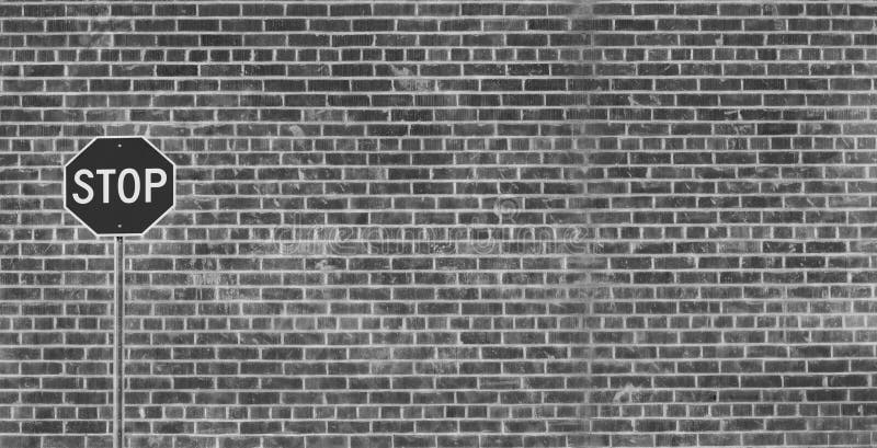 Stop Sign in Front of Brick Wall Stock Photo - Image of sign ...