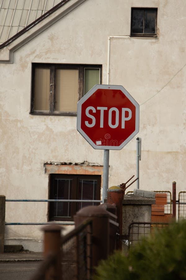 Stop Sign in Front of a Building Stock Photo - Image of communication ...