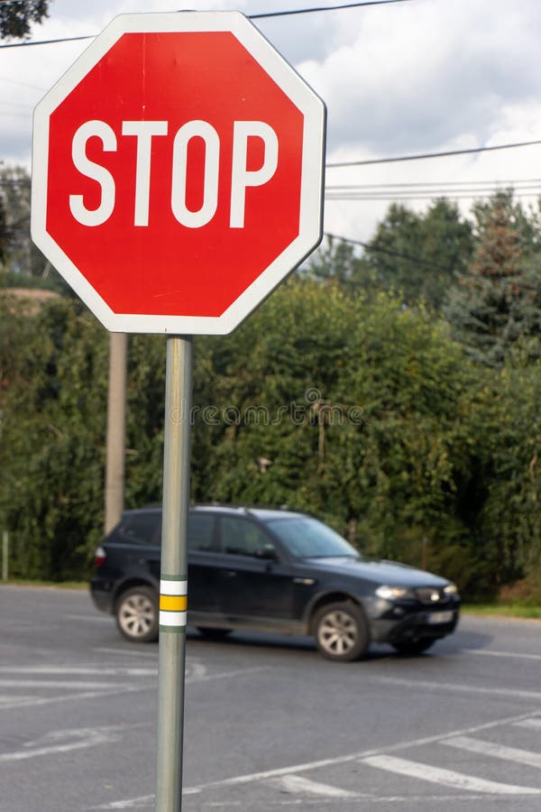 Stop Sign in Front of a Crossing with a Rides Car Stock Image - Image ...