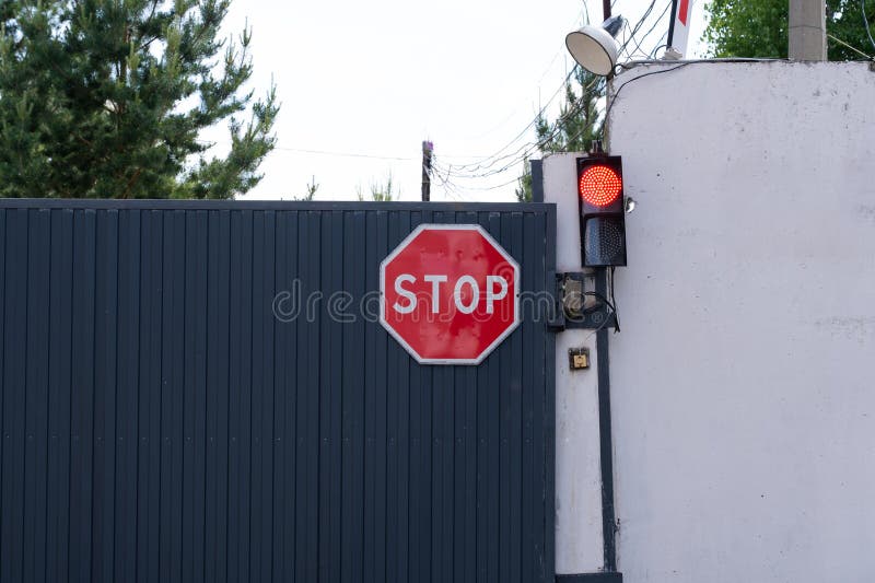 Stop Sign on Gate. Traffic Light on Wall with Red Warning Sign. Stock ...