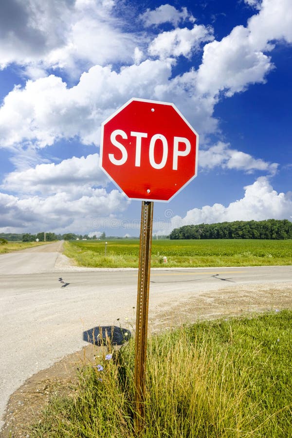 An 8-sided Red STOP Sign and Rectangular Shaped Green Guide Road Sign ...