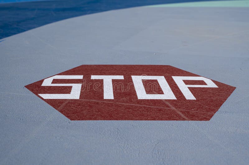 A Stop Sign is Painted on a Grey Surface. Stock Image - Image of ...