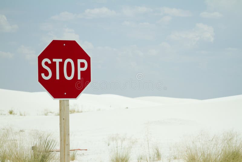 Stop sign in sand stock photo. Image of symbol, vacation - 1104564