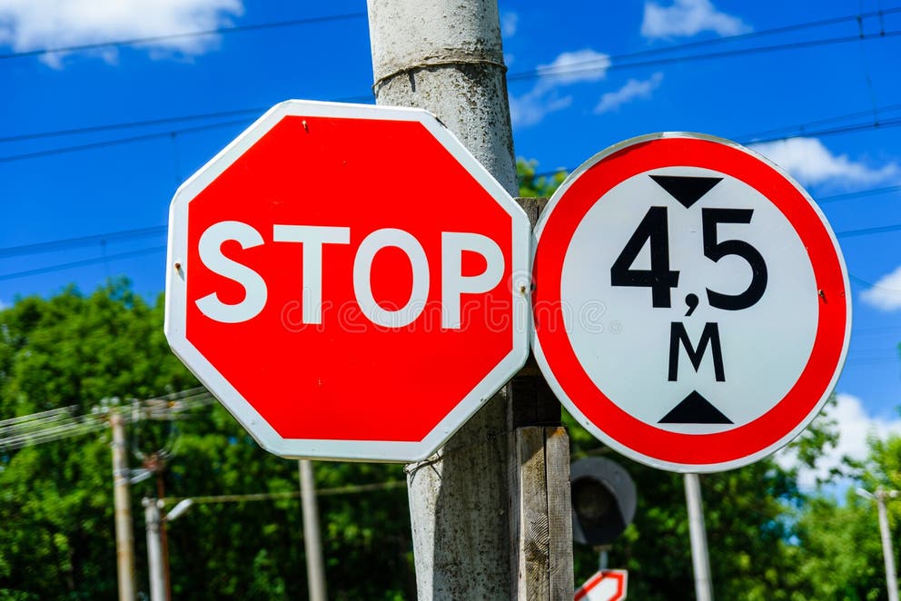 Stop Sign on a Post at Roadside Against Blue Sky Stock Photo - Image of ...