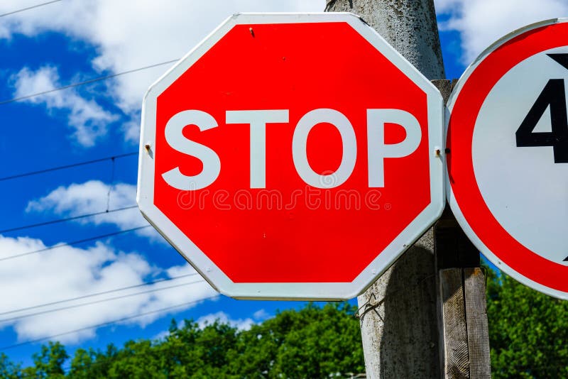 Stop Sign on a Post at Roadside Against Blue Sky Stock Image - Image of ...