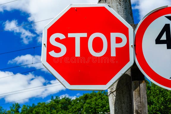 Stop Sign on a Post at Roadside Against Blue Sky Stock Image - Image of ...