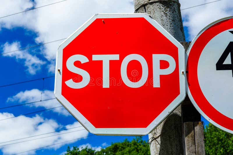 Stop Sign on a Post at Roadside Against Blue Sky Stock Image - Image of ...