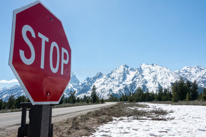A Stop Sign is on a Road in Front of a Mountain Range Stock Image ...