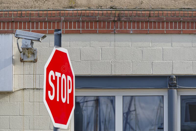 Stop Sign and Security Camera on Building Stock Photo - Image of ...
