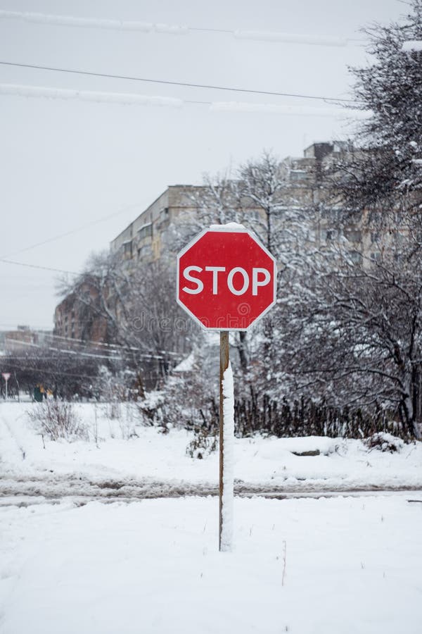 Stop sign on a snowy road stock image. Image of post - 73456253