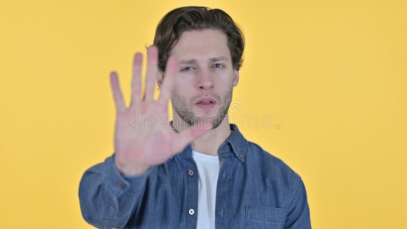 Stop Sign by Young Man, Hand Gesture on Yellow Background Stock Video ...