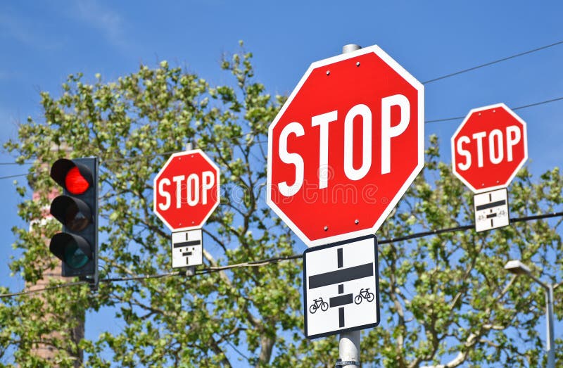 Stop Signs at the Road Crossing Stock Photo - Image of hanging, light ...