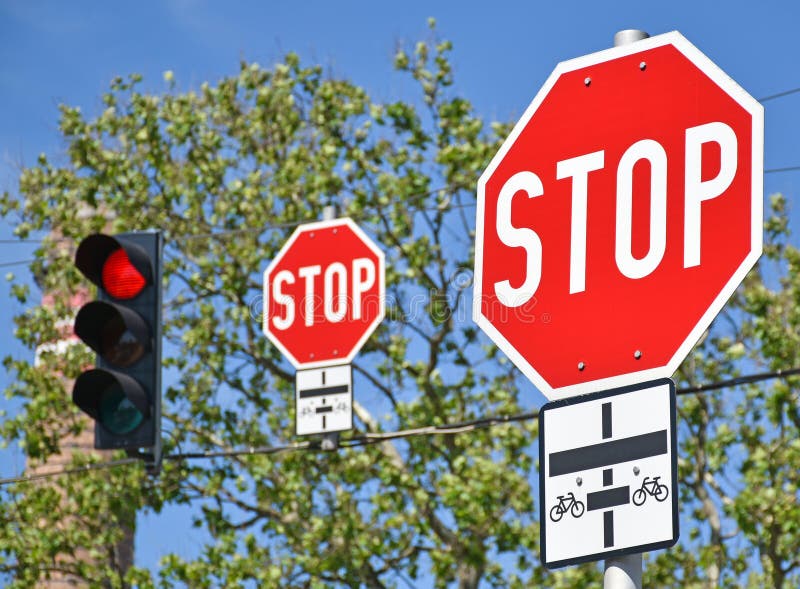 Stop Signs at the Road Crossing Stock Photo - Image of angle, hanging ...