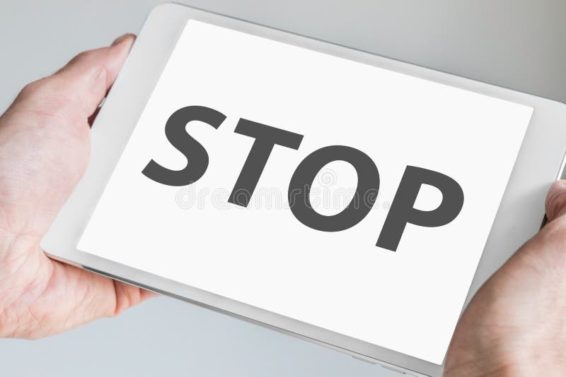 Stop Text Displayed on Touch Screen of Modern Tablet. Hands Holding ...