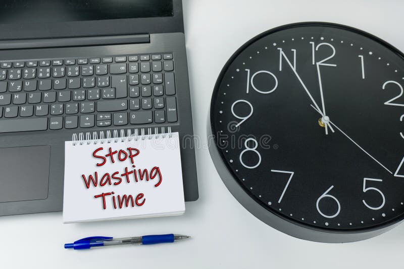Stop Wasting Time Sign Written on the Laptop with the Clock Stock Image ...