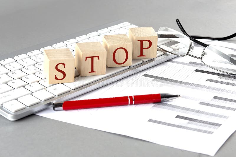 STOP Written on a Wooden Cube on the Keyboard with Chart on Grey ...