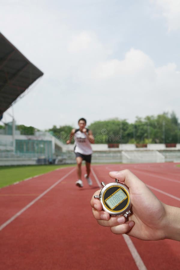 Man with Stopwatch Timing Woman Running Stock Photo - Image of ...