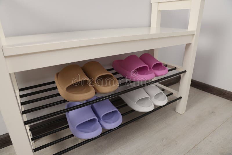 Storage Bench with Pairs of Rubber Slippers in Room Stock Image - Image ...