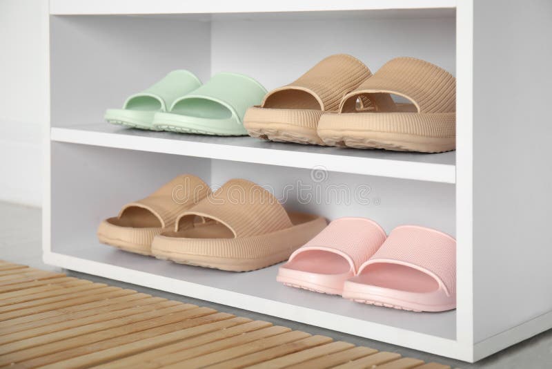 Storage Cabinet with Different Pairs of Rubber Slippers Indoors Stock ...