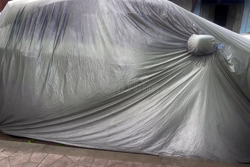 The Car Under the Protective Cover is in the Showroom Stock Photo ...