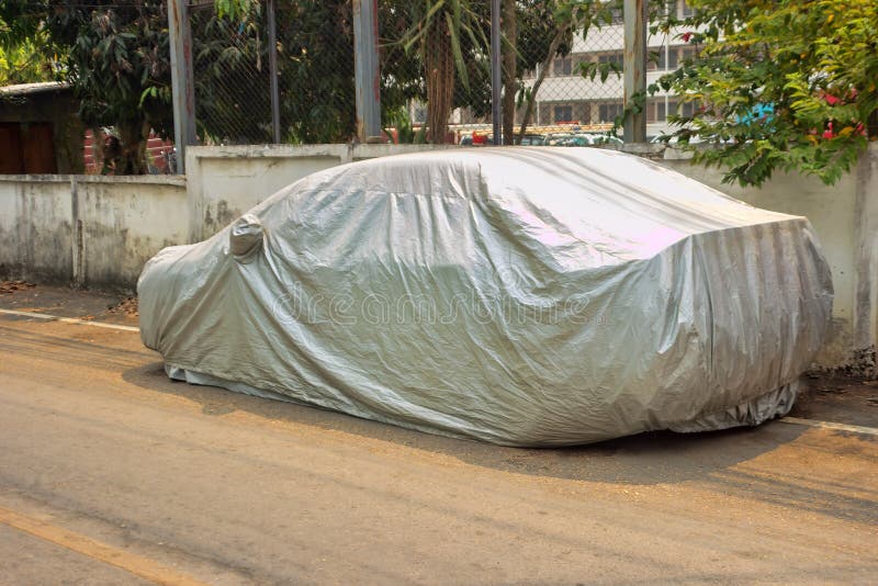 The Car Under the Protective Cover is in the Showroom Stock Photo ...