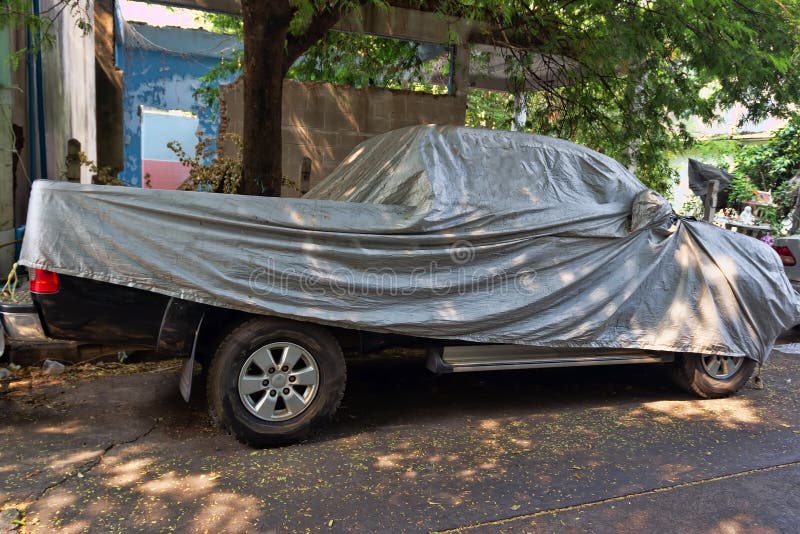 The Car Under the Protective Cover is in the Showroom Stock Photo ...
