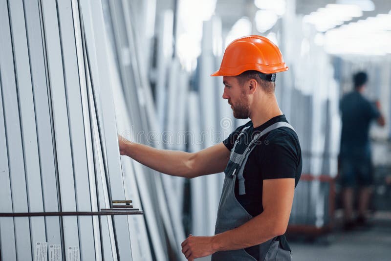 In the Storage with Many of Objects. Industrial Worker Indoors in ...