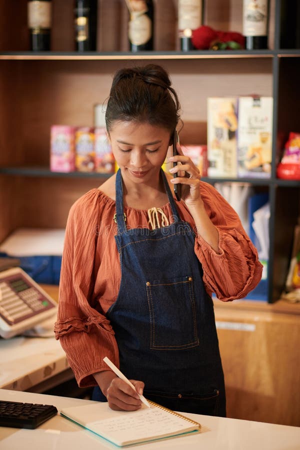 Store Worker Talking on Phone Stock Image - Image of list, smiling ...