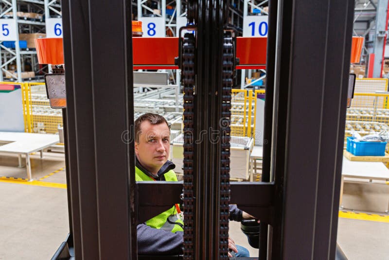 Storehouse Employee in Uniform Working on Forklift in Modern Automatic ...