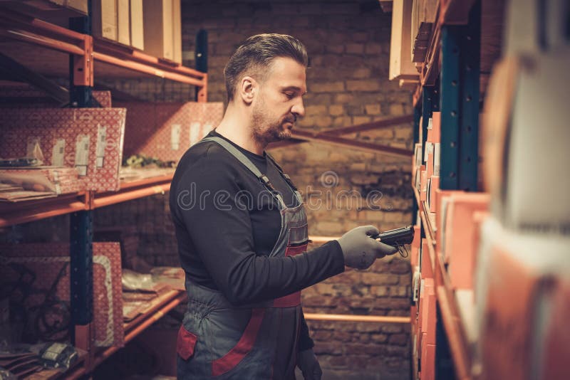 Storekeeper with Handheld Barcode Scanner Working in a Warehouse Stock ...