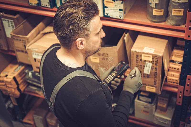 Storekeeper with Handheld Barcode Scanner Working in a Warehouse Stock ...