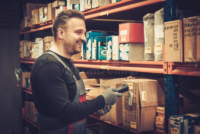 Storekeeper with Handheld Barcode Scanner Working in a Warehouse Stock ...