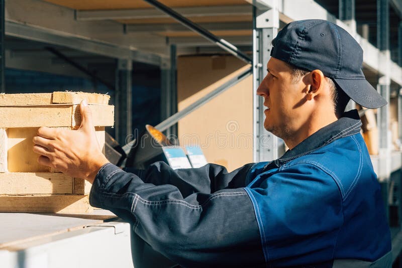 Storekeeper Lays Out Boxes on Racks in Warehouse. Caucasian Worker at ...