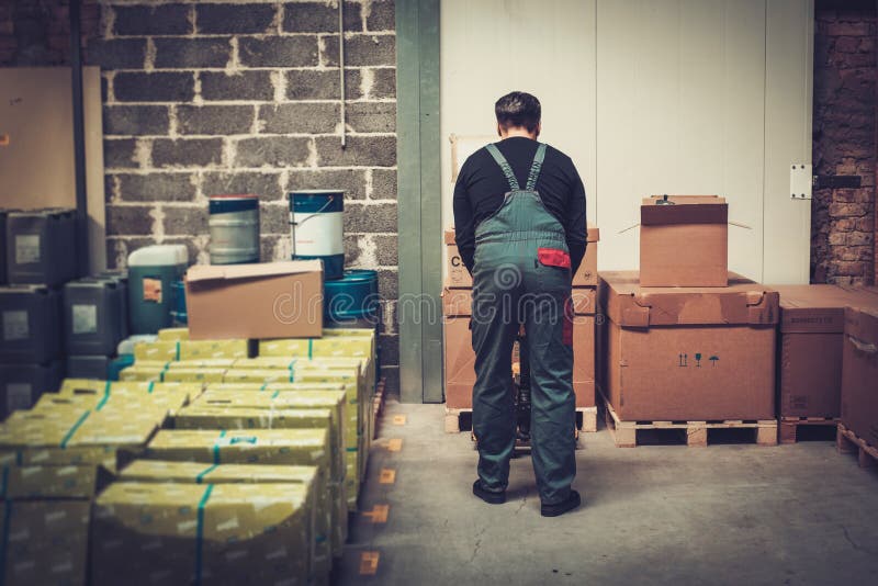 Storekeeper Working with Pallet Truck in a Warehouse Stock Image ...