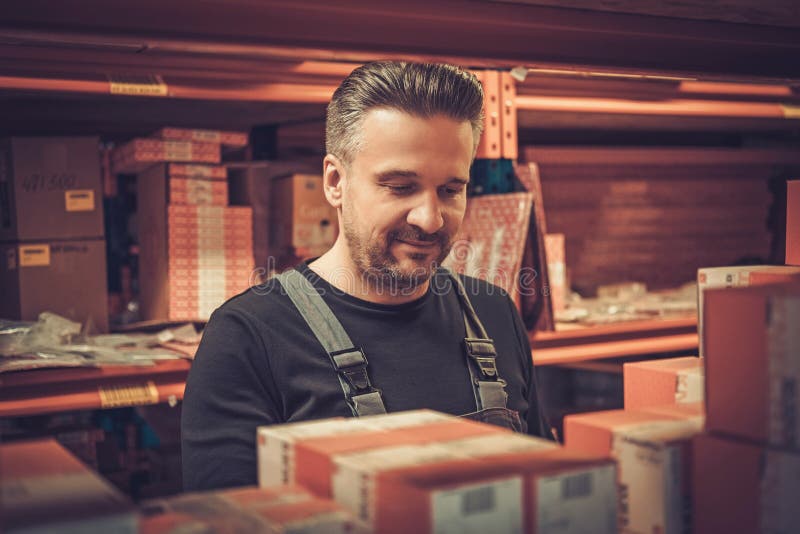 Storekeeper Working in a Warehouse Stock Photo - Image of automobile ...