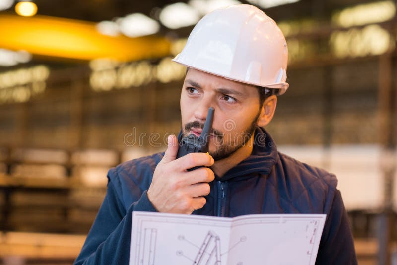 Storeman talking on radio stock image. Image of securityhelmet - 197918419