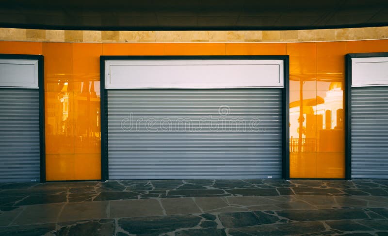 Stores Next To Each Other with Shutters Down Stock Photo - Image of ...