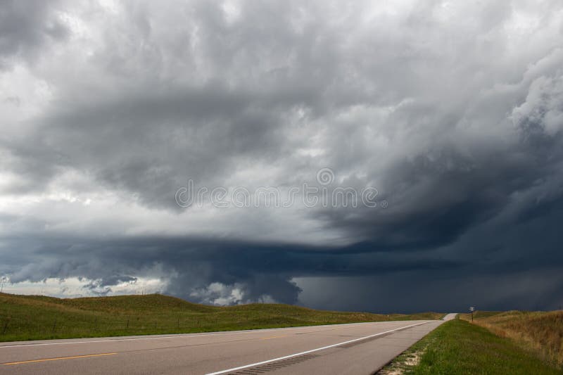 A Storm Begins To Form a Wall Cloud Underneath Its Base Along a Highway ...