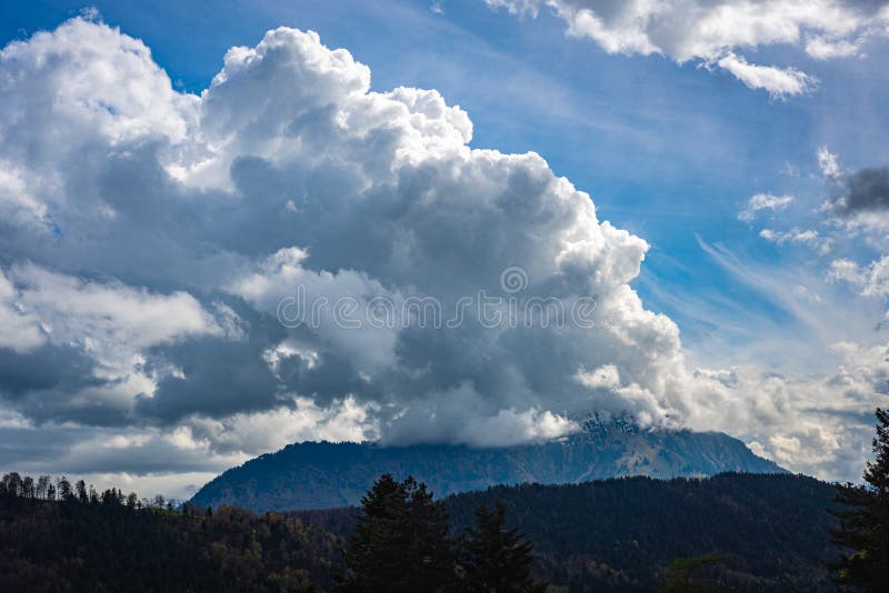 A Storm Cloud is Forming Over a Mountain Stock Photo - Image of ...