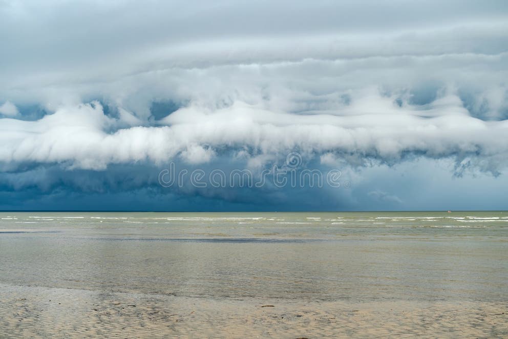 Storm Clouds Forming Over a Beach. Dense, Towering Raincloud before the ...
