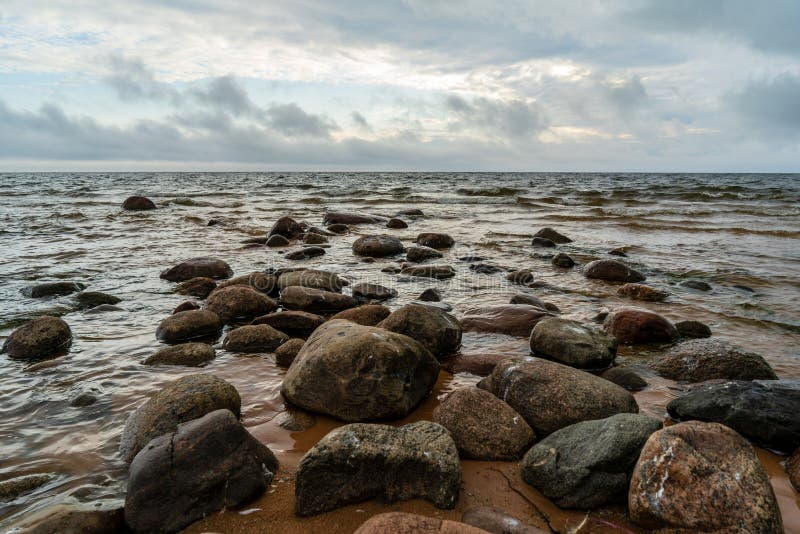 Storm Clouds Forming Over Clear Sea Beach with Rocks and Clear S Stock ...