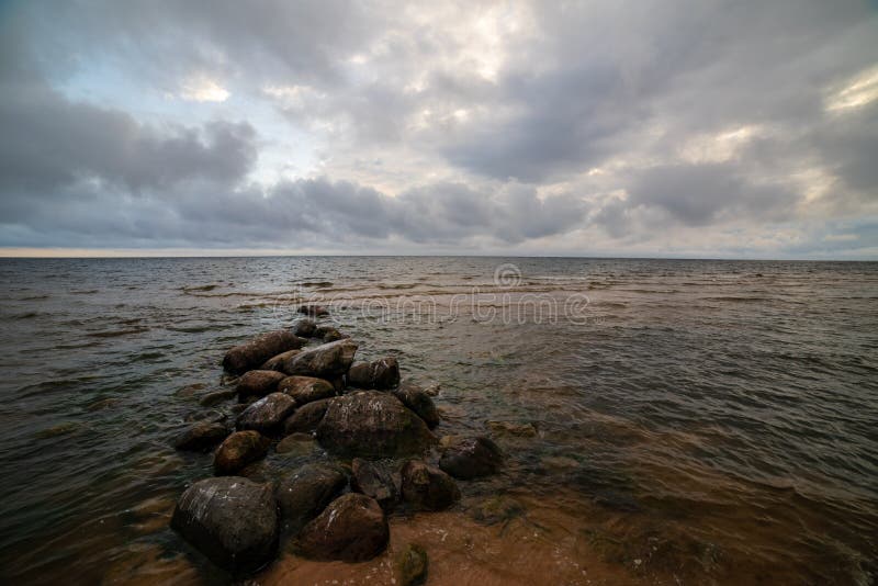 Storm Clouds Forming Over Clear Sea Beach with Rocks and Clear S Stock ...